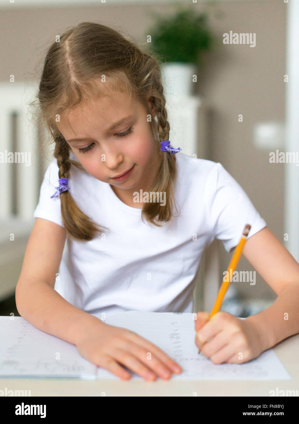 Cute little girl doing her homework for school Stock Photo - Alamy