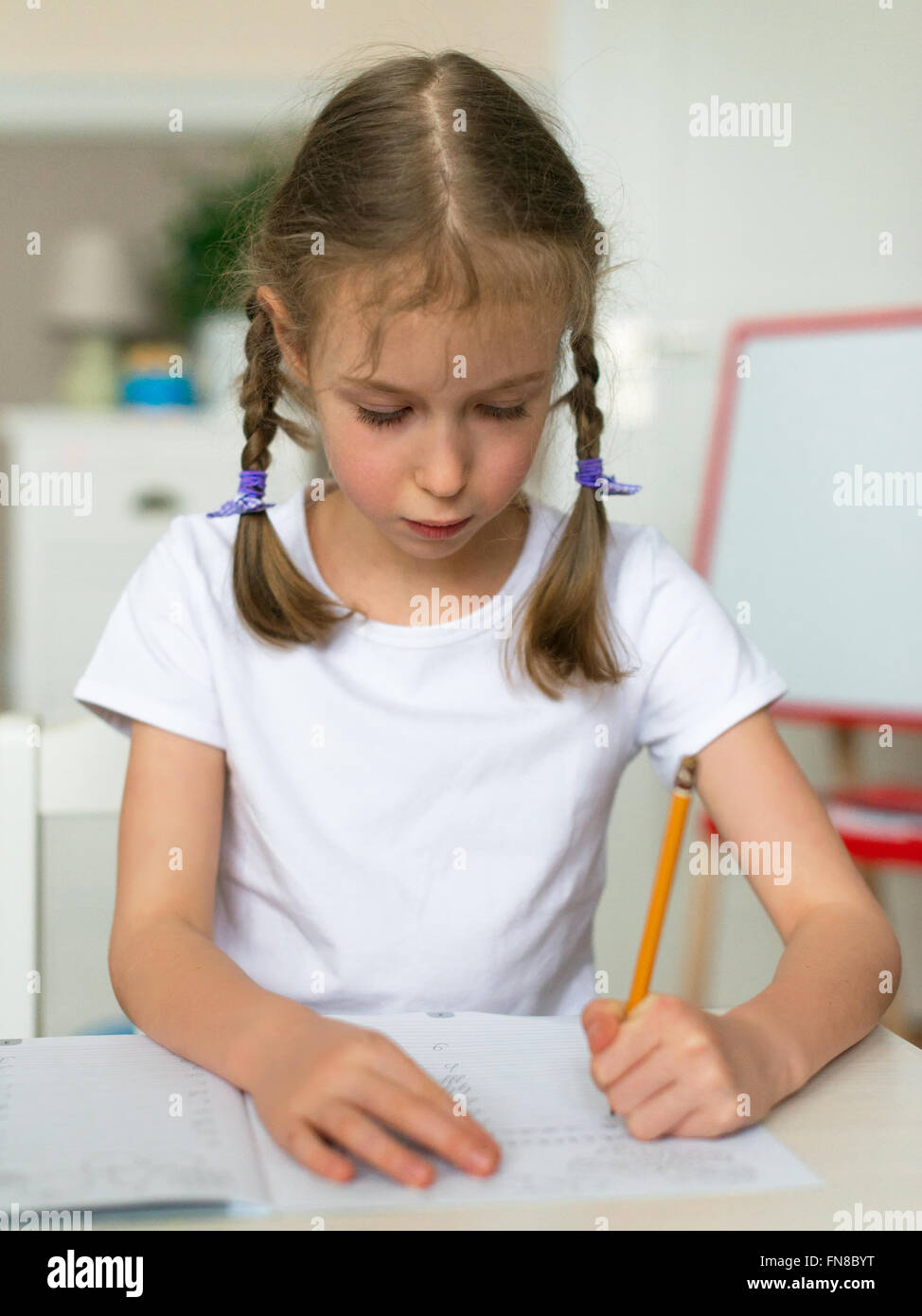 Cute little girl doing her homework for school Stock Photo - Alamy