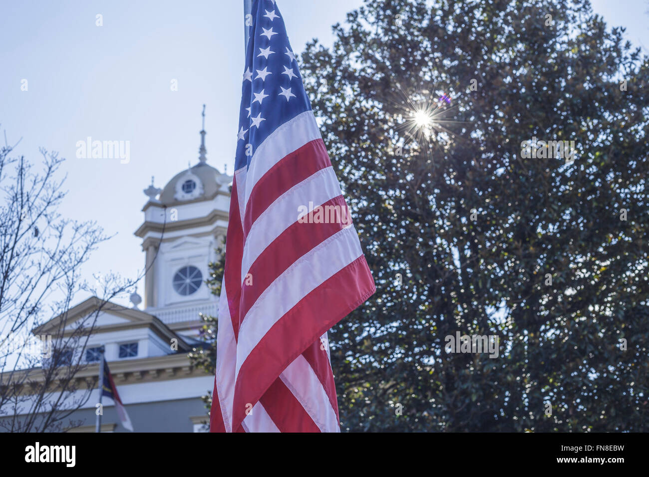 An American flag in front of a small town courthouse Stock Photo - Alamy