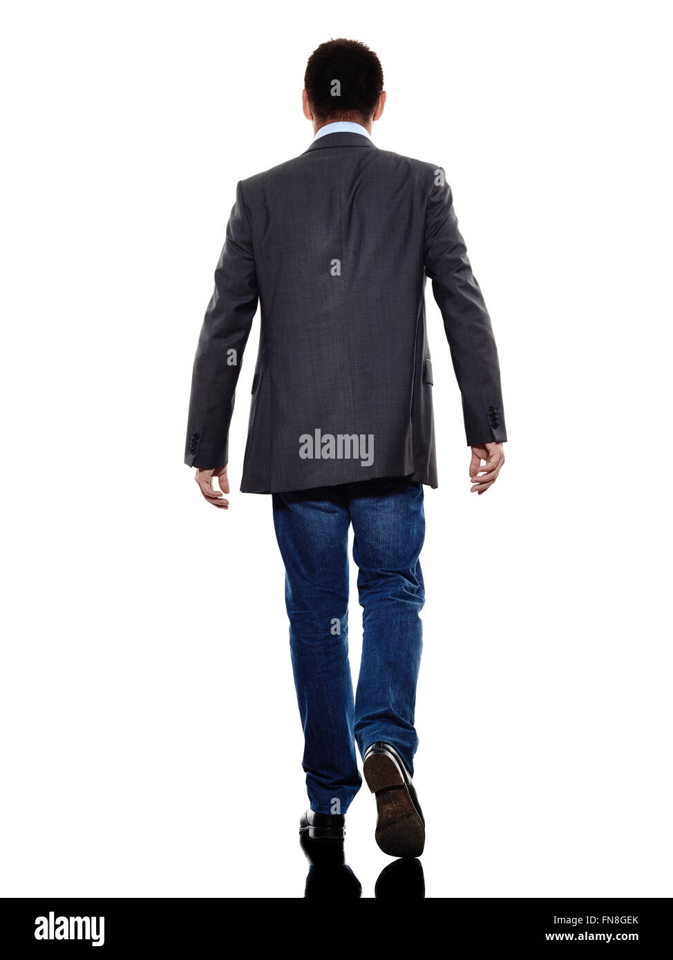 one caucasian business man walking rear view in silhouette on white ...