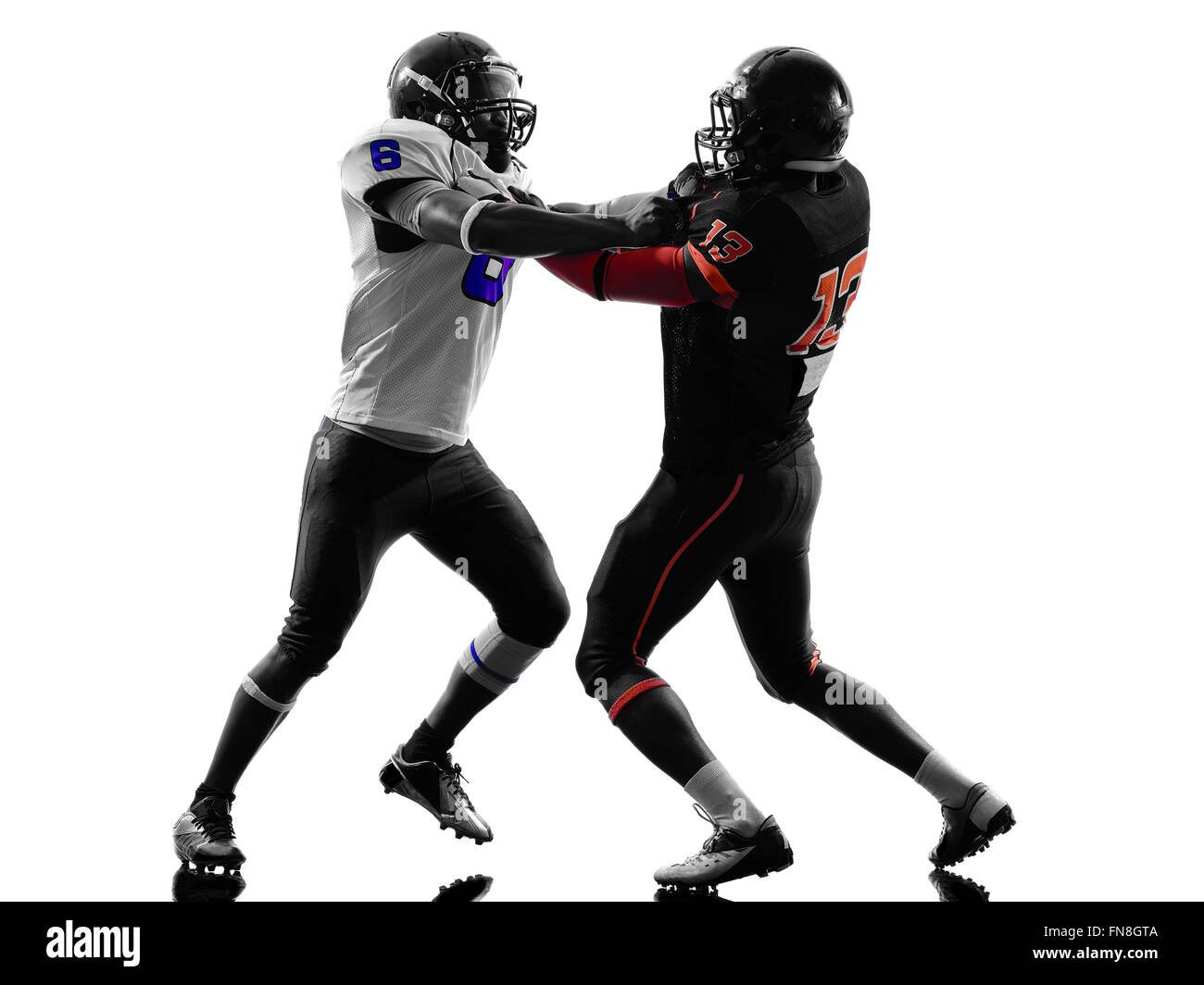two american football players on scrimmage holding in silhouette shadow ...