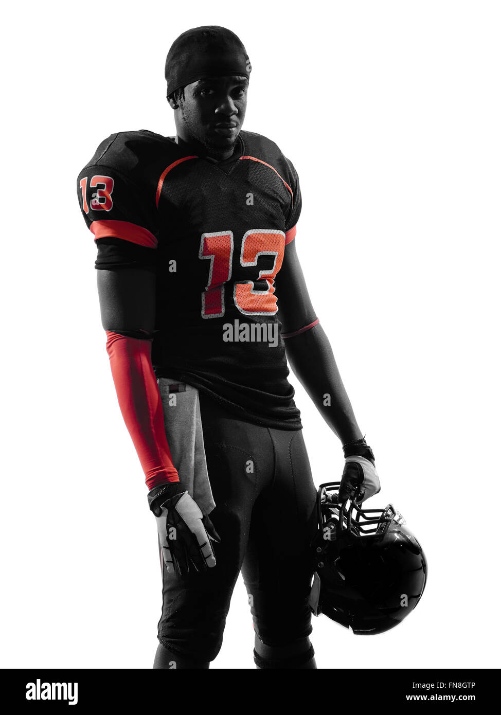 one american football player standing in silhouette shadow on white ...