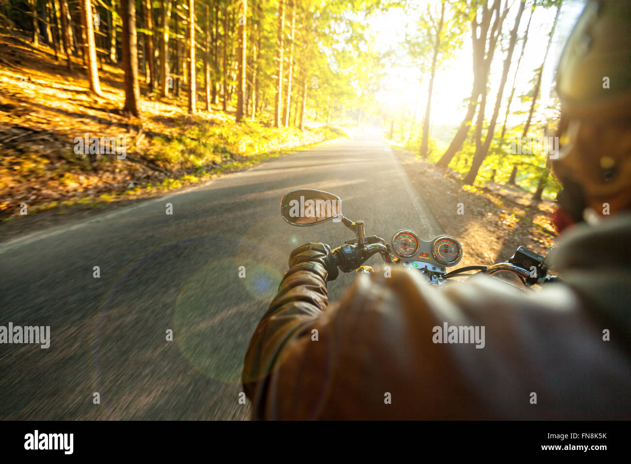 Motorcyclist riding motorbike in sunny morning Stock Photo - Alamy