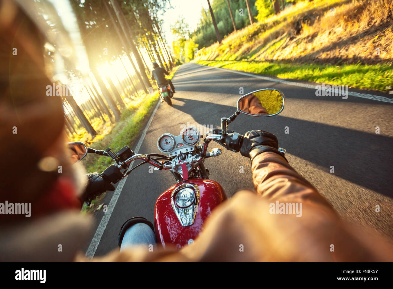 Motorcyclist riding motorbike in sunny morning Stock Photo - Alamy