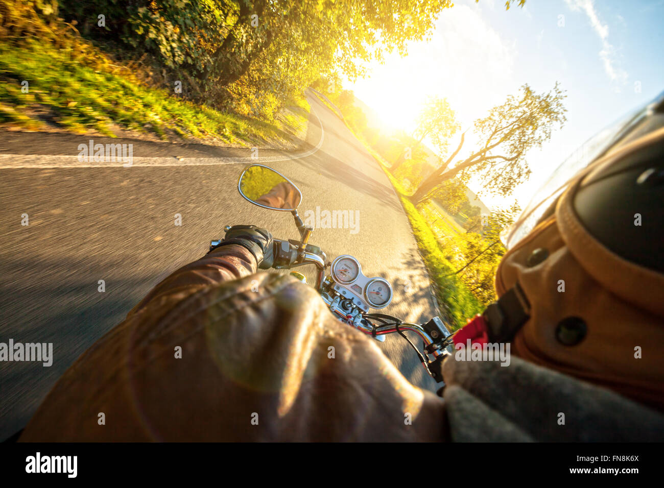 Motorcyclist riding motorbike in sunny morning Stock Photo - Alamy