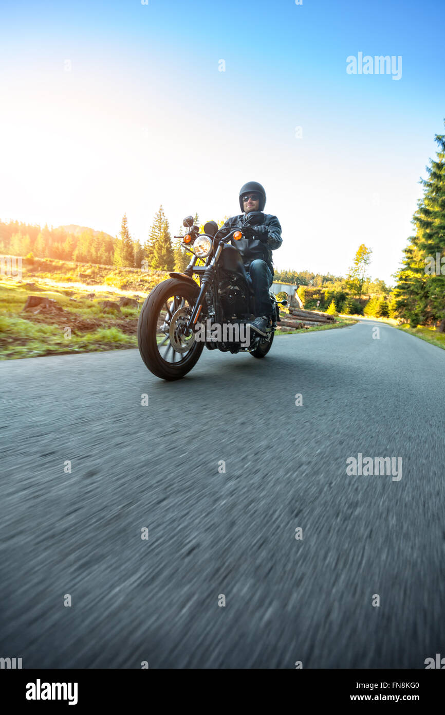 Motorcyclist riding chopper on a road Stock Photo - Alamy