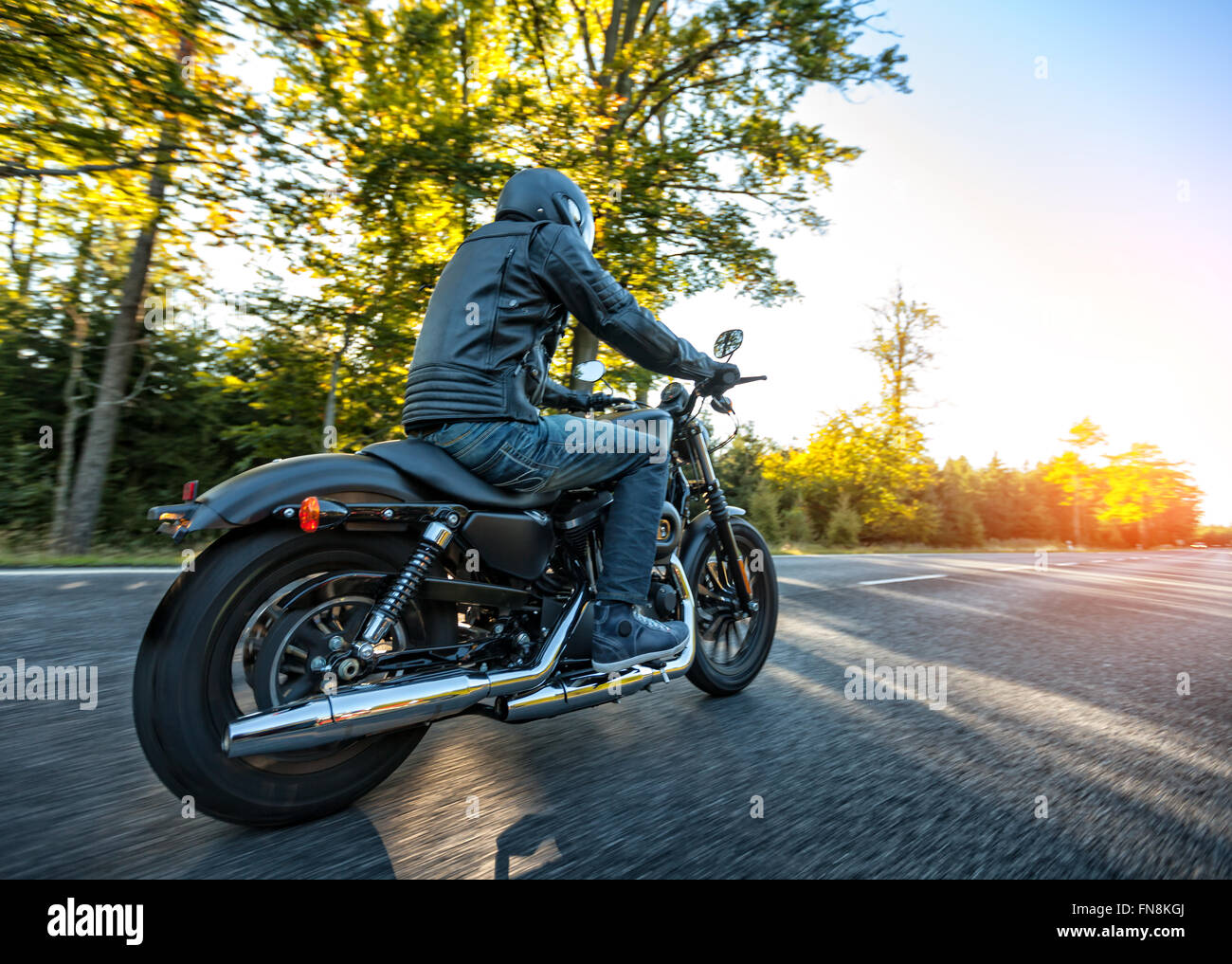 Motorcyclist riding chopper on a road Stock Photo - Alamy