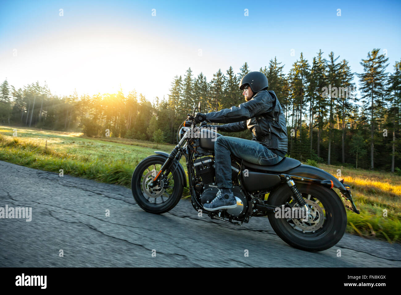 Motorcyclist riding chopper on a road Stock Photo - Alamy
