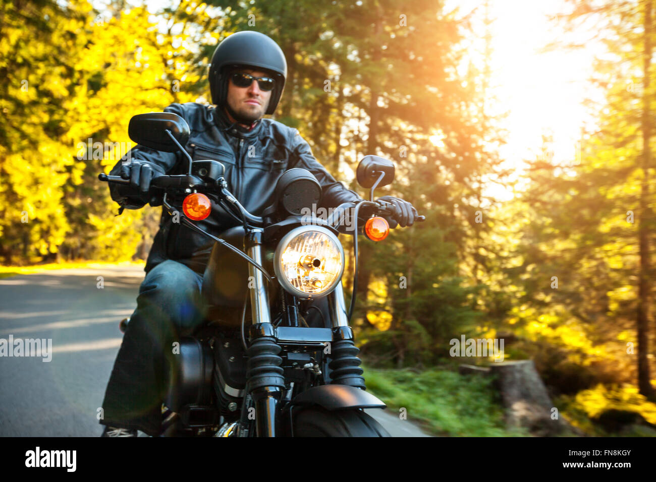 Motorcyclist riding chopper on a road Stock Photo - Alamy