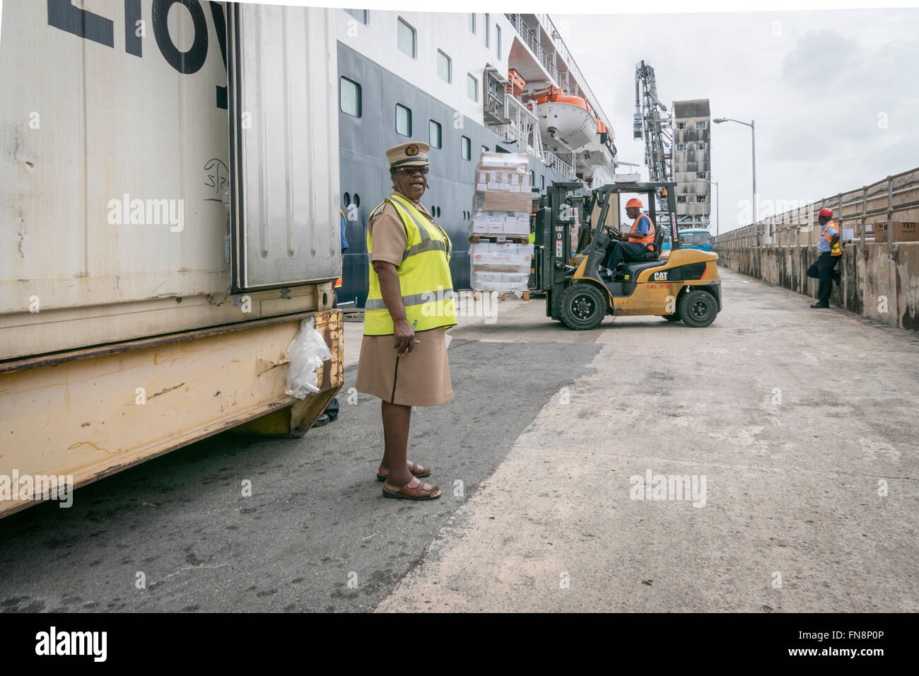 Port staff loading provisions onto ship by fork lift truck at the ...