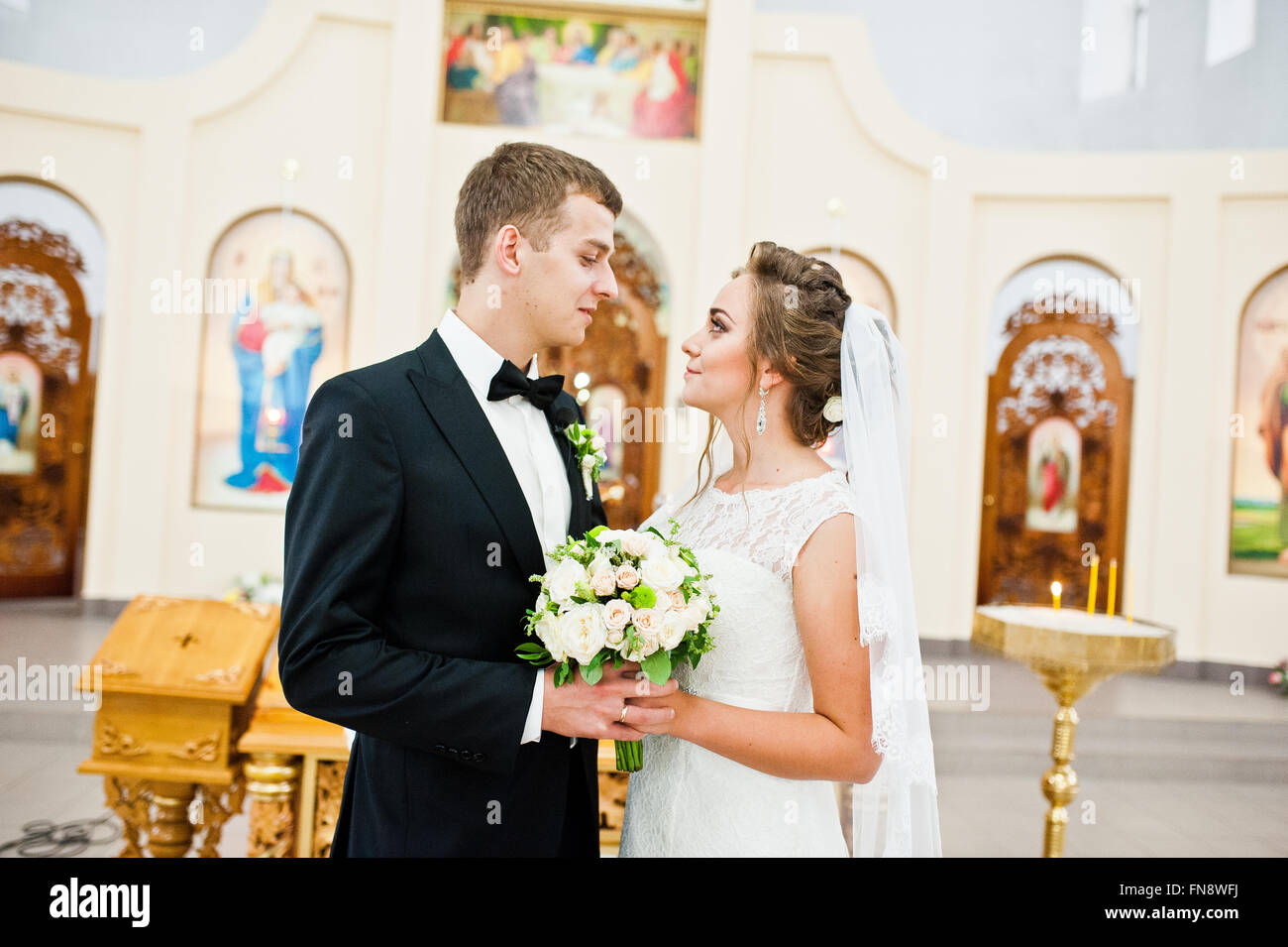 Wedding couple in love at church Stock Photo - Alamy