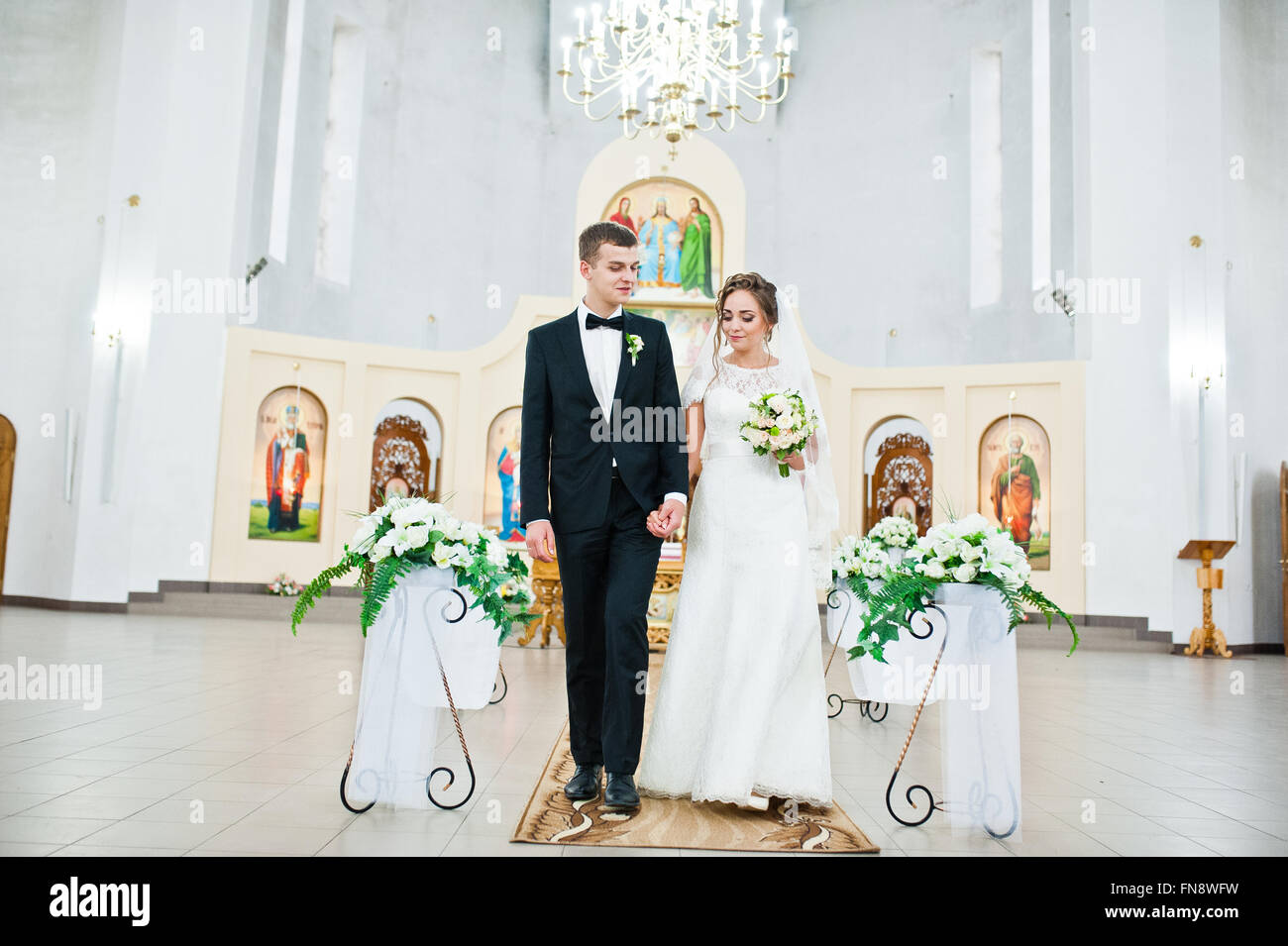 Wedding couple in love at church Stock Photo - Alamy