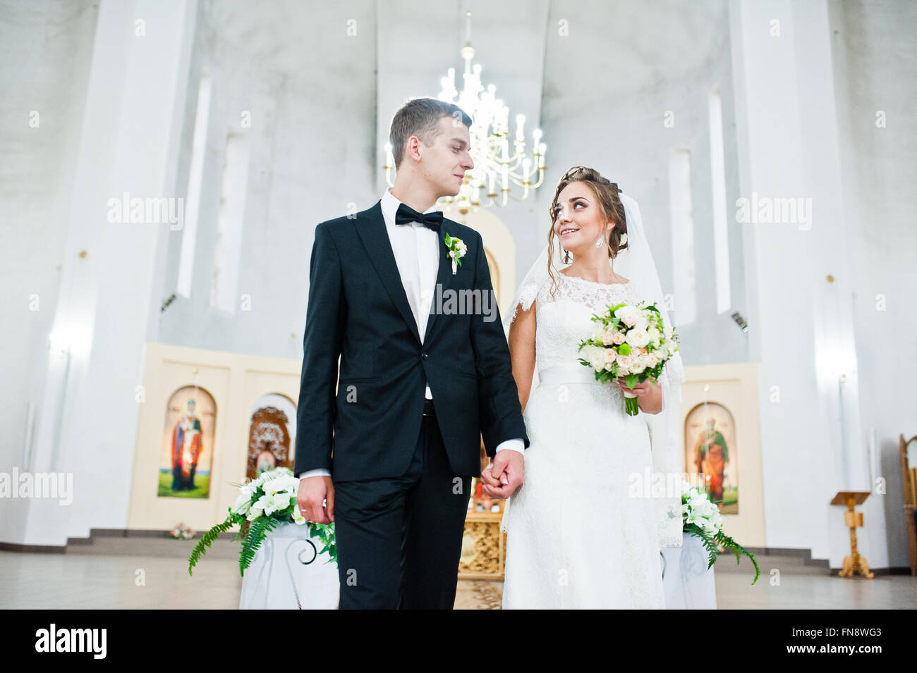 Wedding couple in love at church Stock Photo - Alamy
