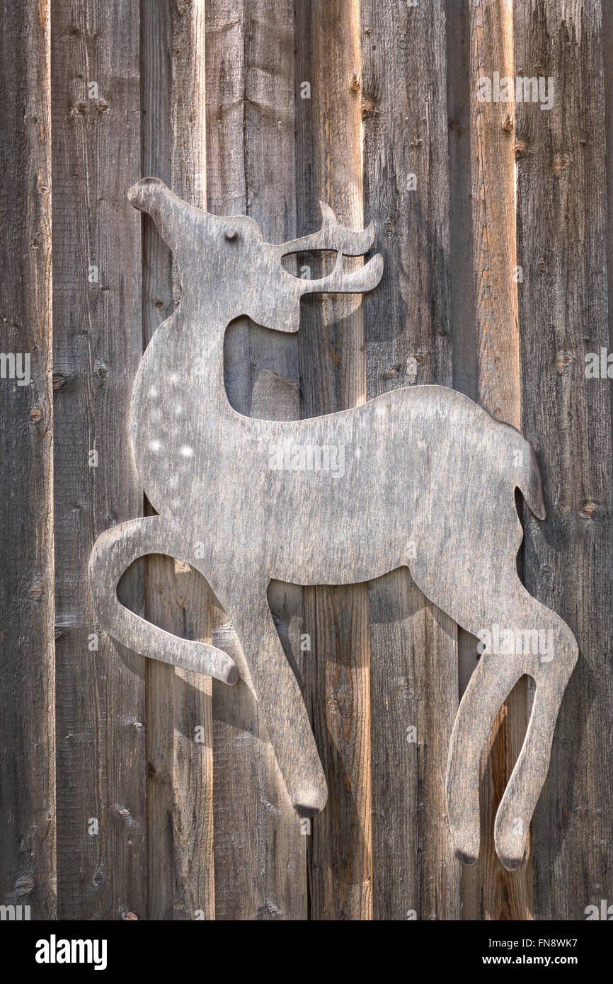 Deer made of wood on a board wall, taken in vertical format Stock Photo ...