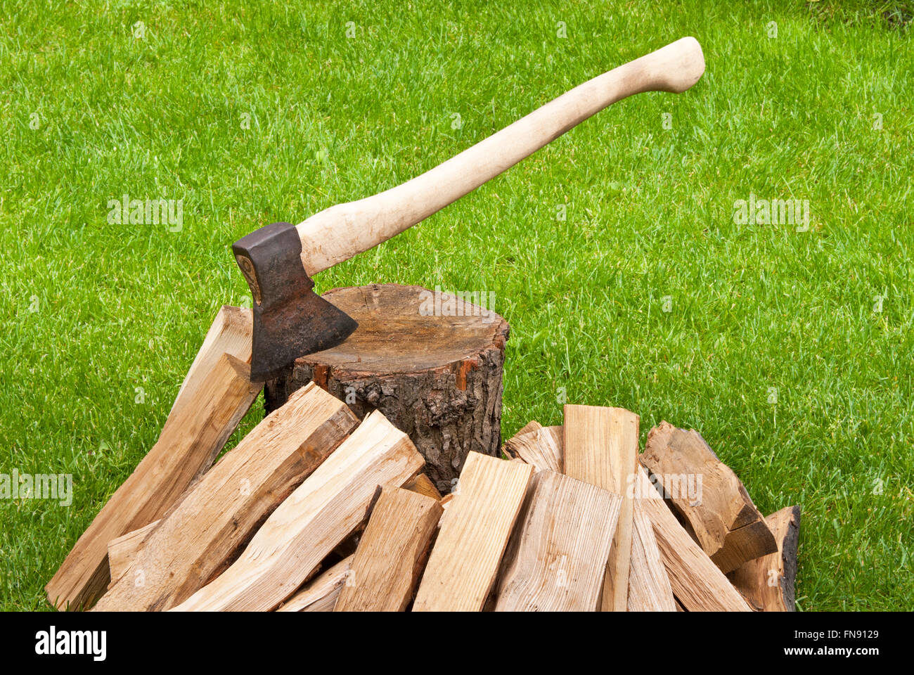 old used ax with a log in the garden Stock Photo - Alamy