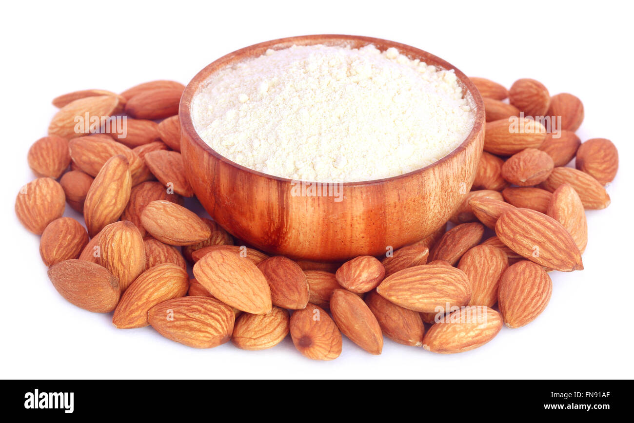 Fresh almonds with flour over white background Stock Photo - Alamy