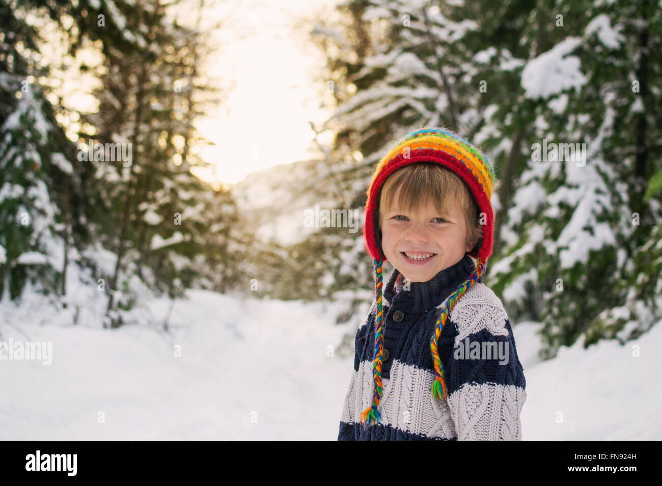 Portrait of a smiling boy standing in snow Stock Photo - Alamy
