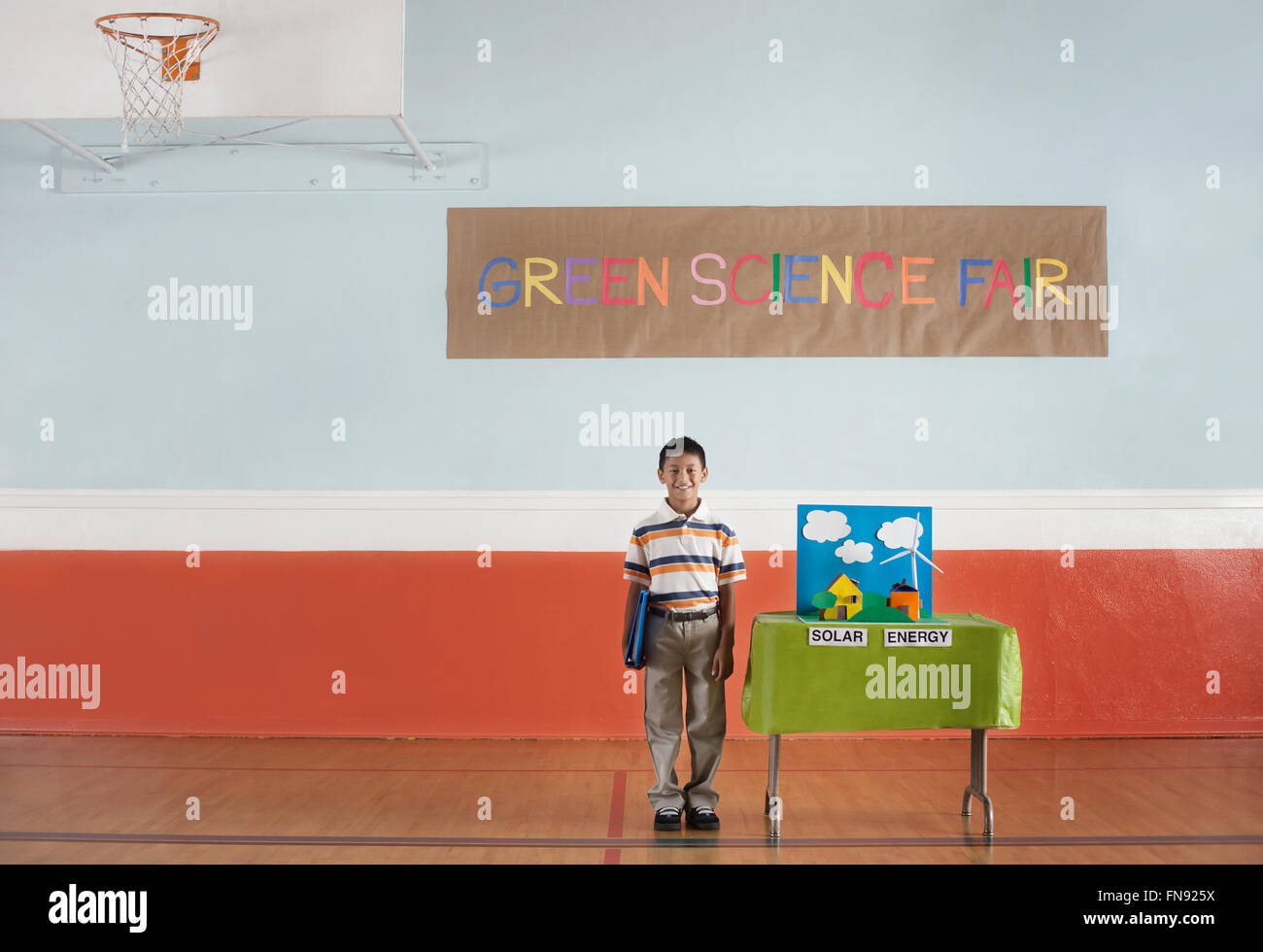 A boy standing under a Green Science Fair sign beside a Solar Power ...