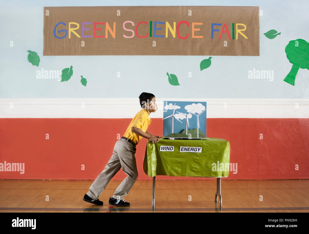 A boy pushing a table into a room at the Green Science Fair Stock Photo ...