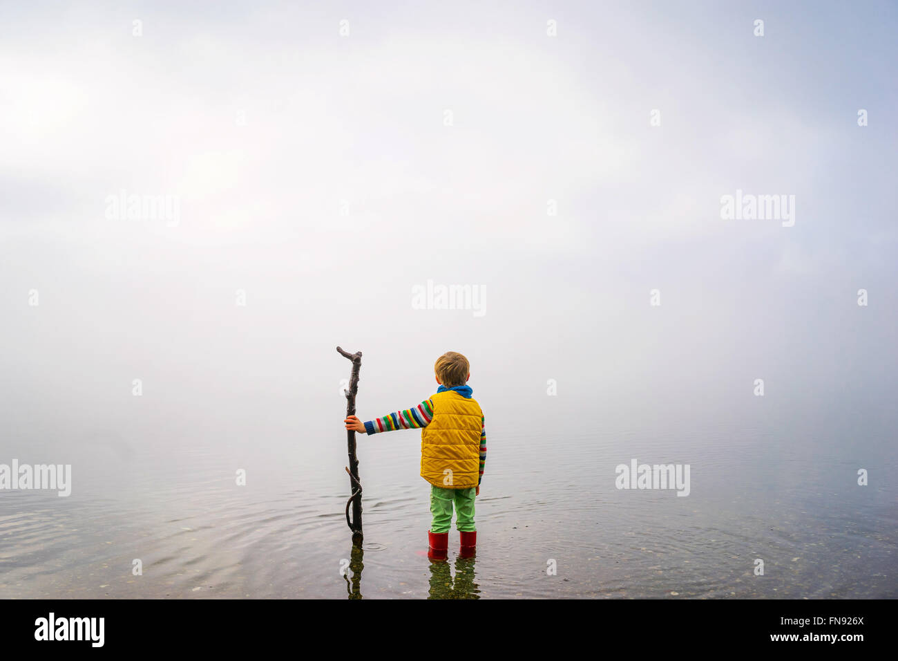 Boy holding a stick hi-res stock photography and images - Alamy
