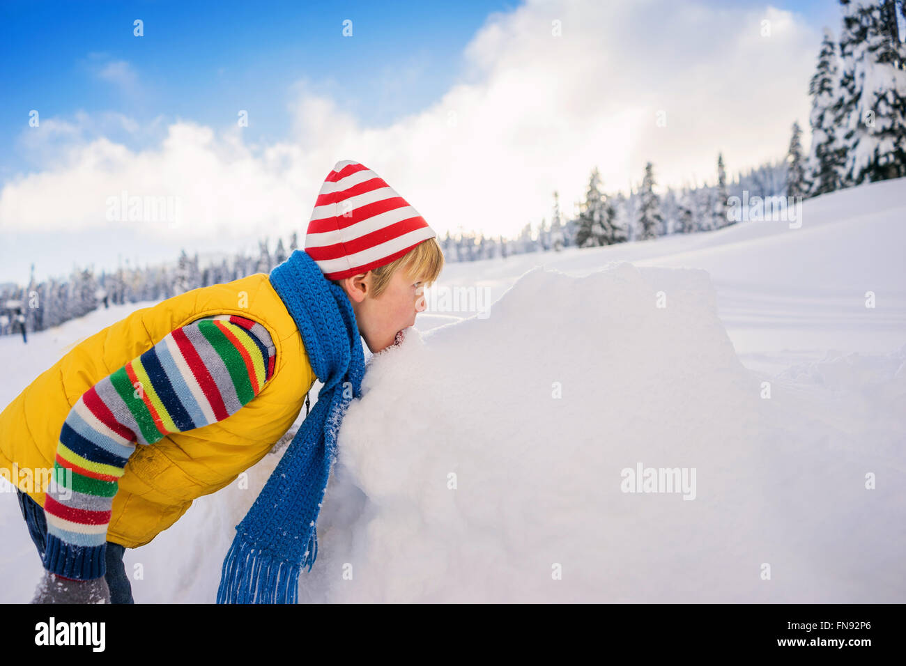 Boy eating snow Stock Photo - Alamy