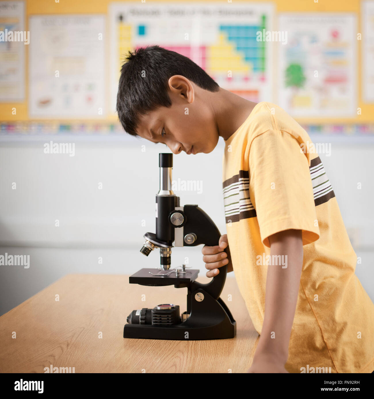 A boy using a microscope in a science lesson Stock Photo - Alamy