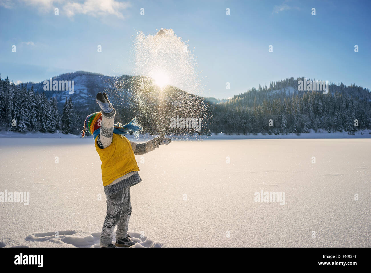 Boy throwing snow in the air Stock Photo - Alamy