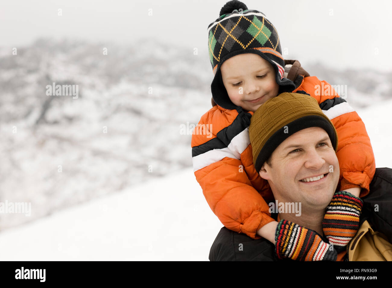 A man carrying a young child on his shoulders Stock Photo - Alamy