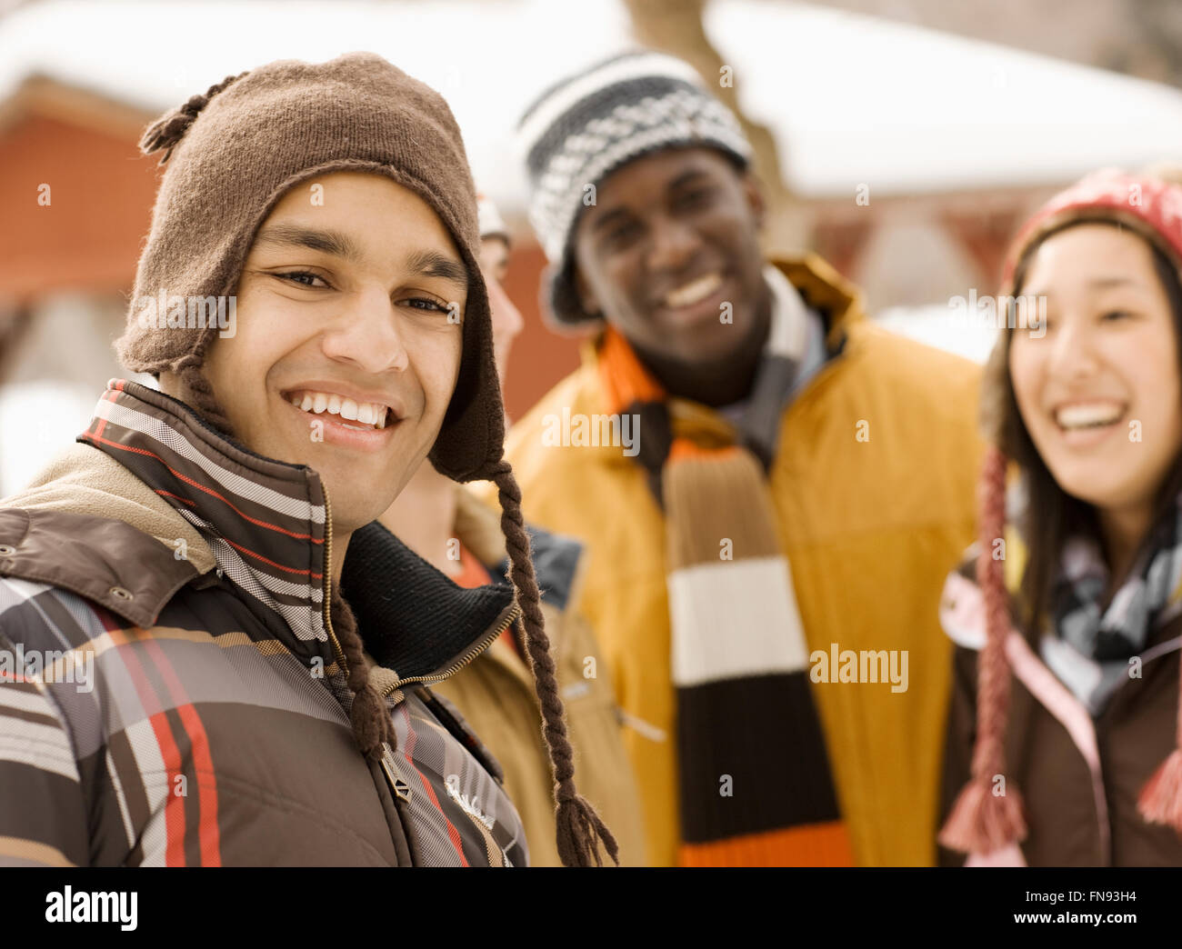 Three young people, two men and a woman in hats and scarves Stock Photo ...