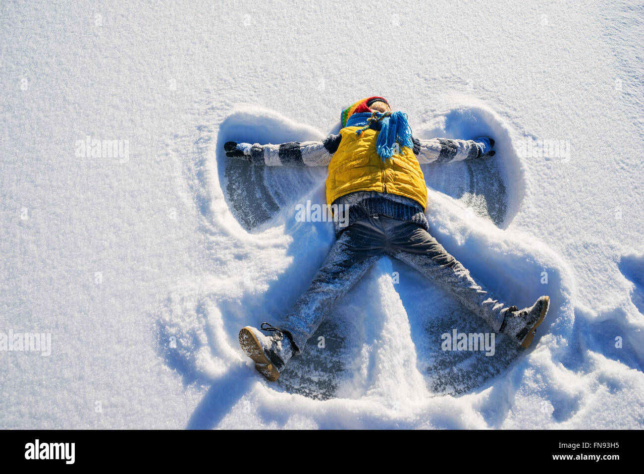 Boy making a snow angel Stock Photo - Alamy