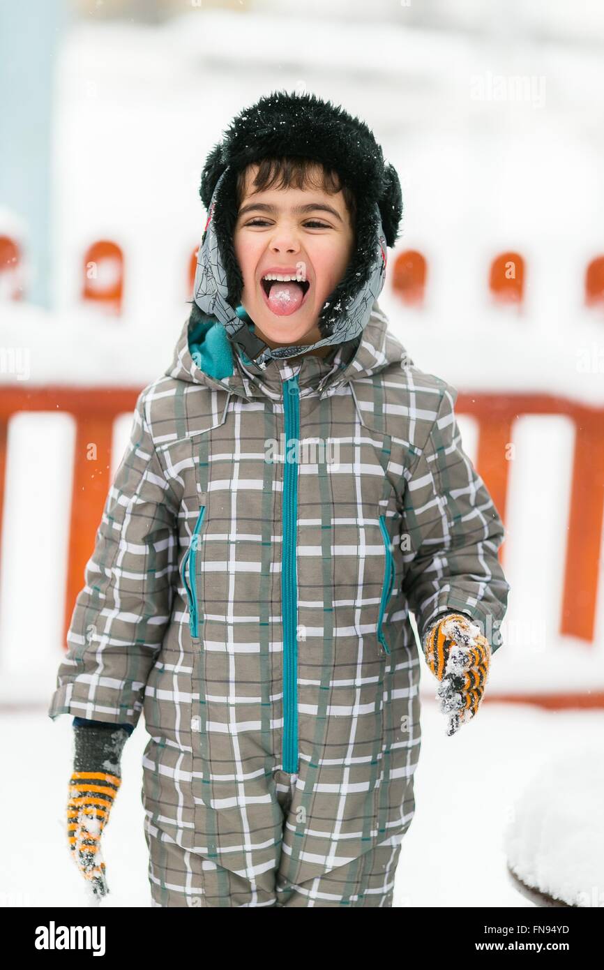 Portrait of little boy catching snowflakes on his tongue Stock Photo ...