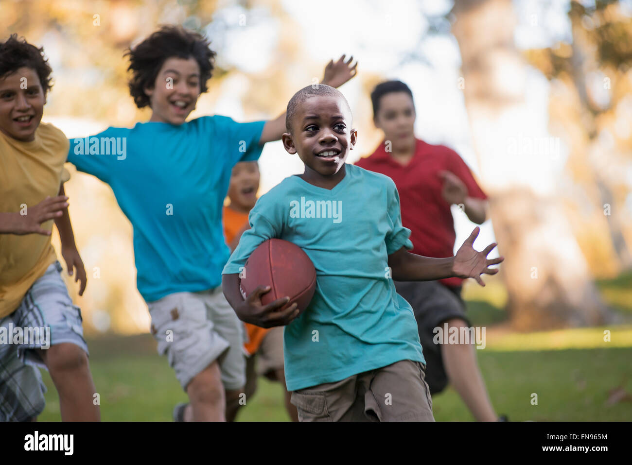 Children running after ball hi-res stock photography and images - Alamy