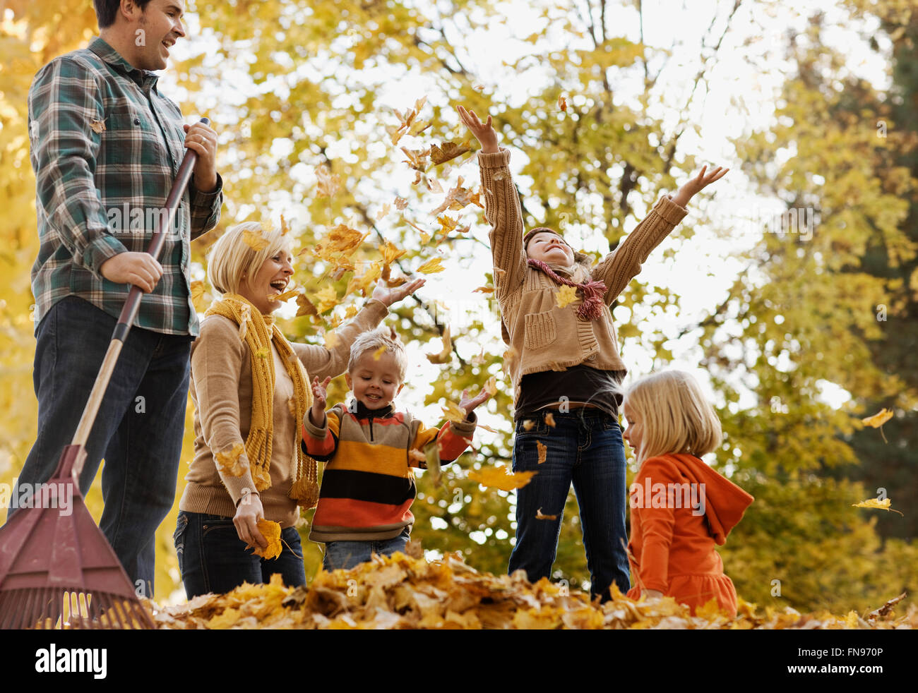Two girls throwing leaves hi-res stock photography and images - Alamy