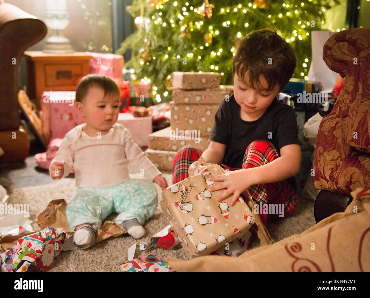 Two boys unwrapping christmas presents hi-res stock photography and ...