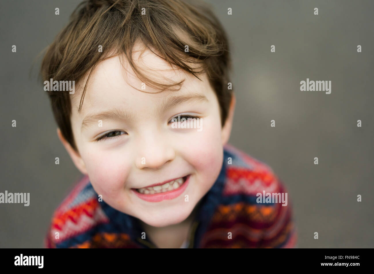 A boy looking up at the camera and smiling Stock Photo - Alamy