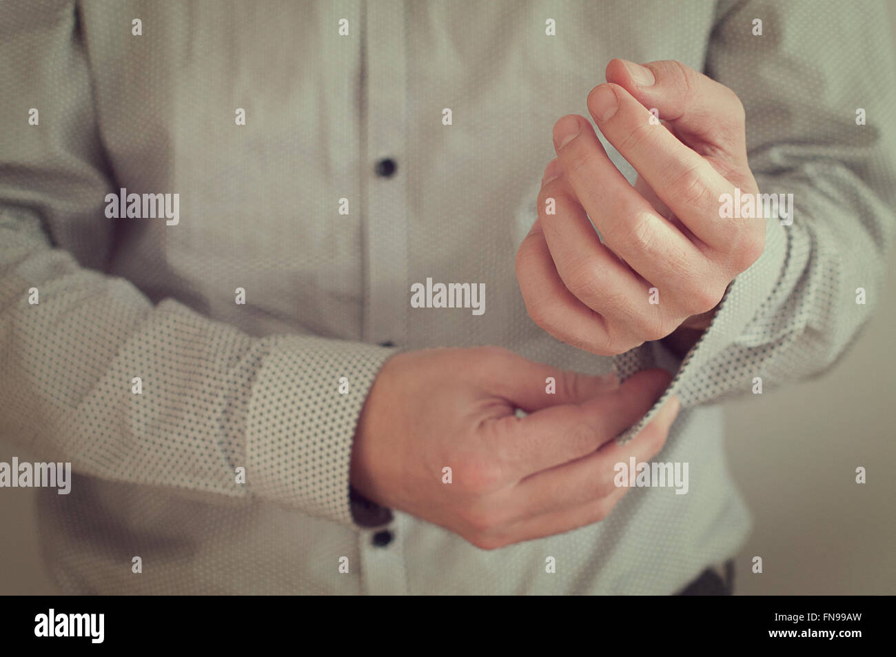 Man buttoning shirt Stock Photo - Alamy