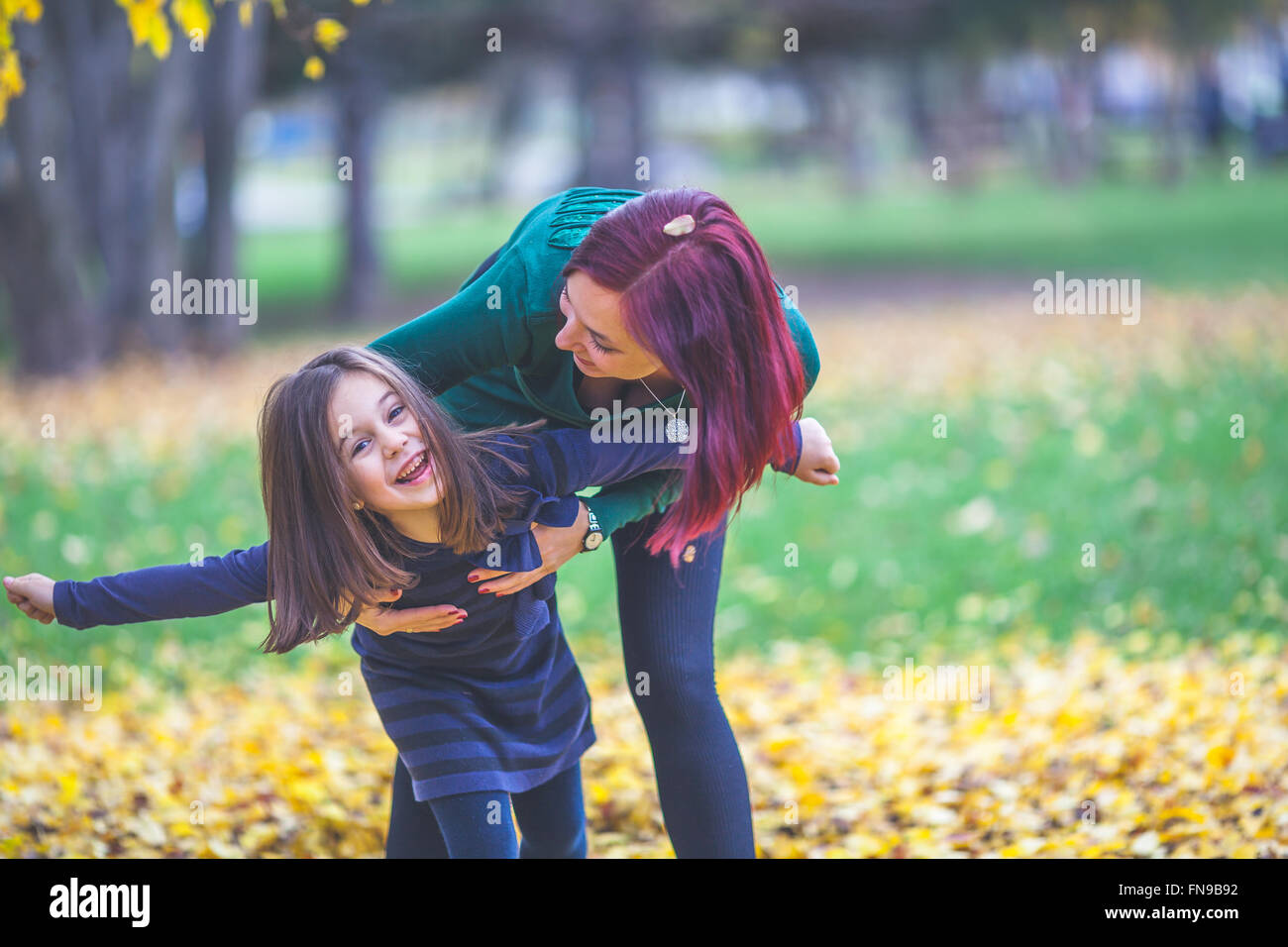 Mother and daughter playing in the park Stock Photo - Alamy