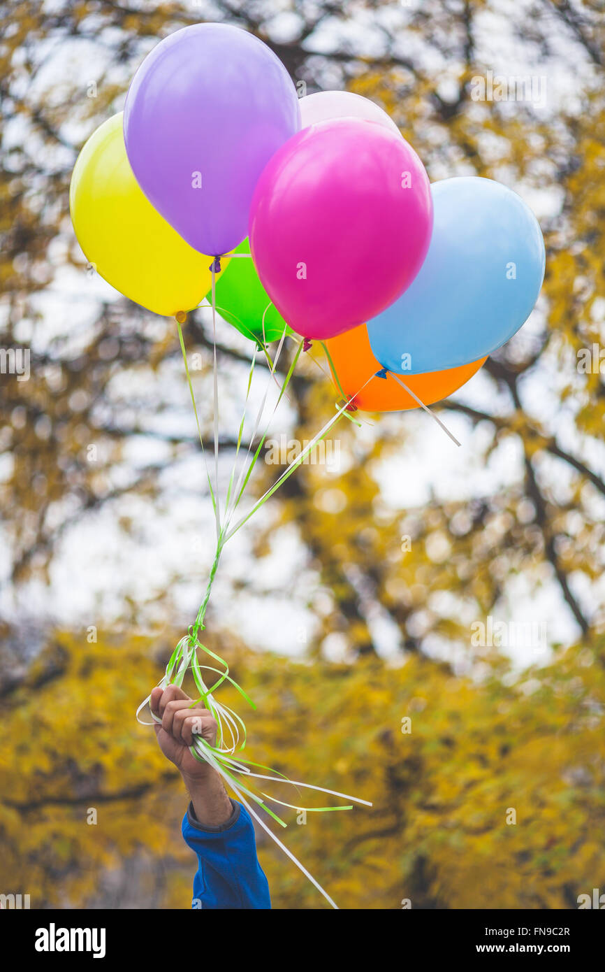 Hand holding balloons hi-res stock photography and images - Alamy