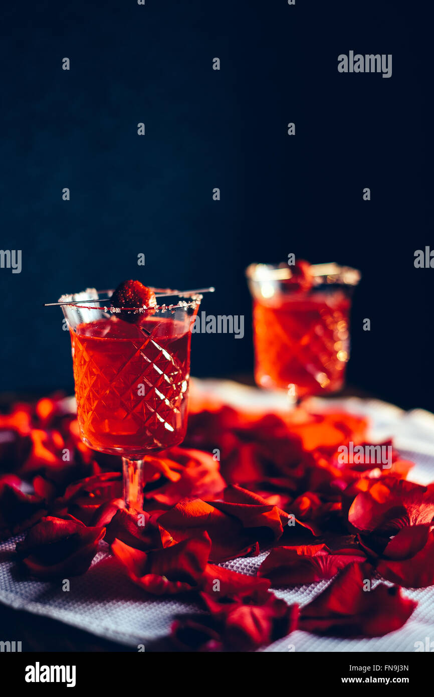 Two red cocktails with rose petals Stock Photo - Alamy