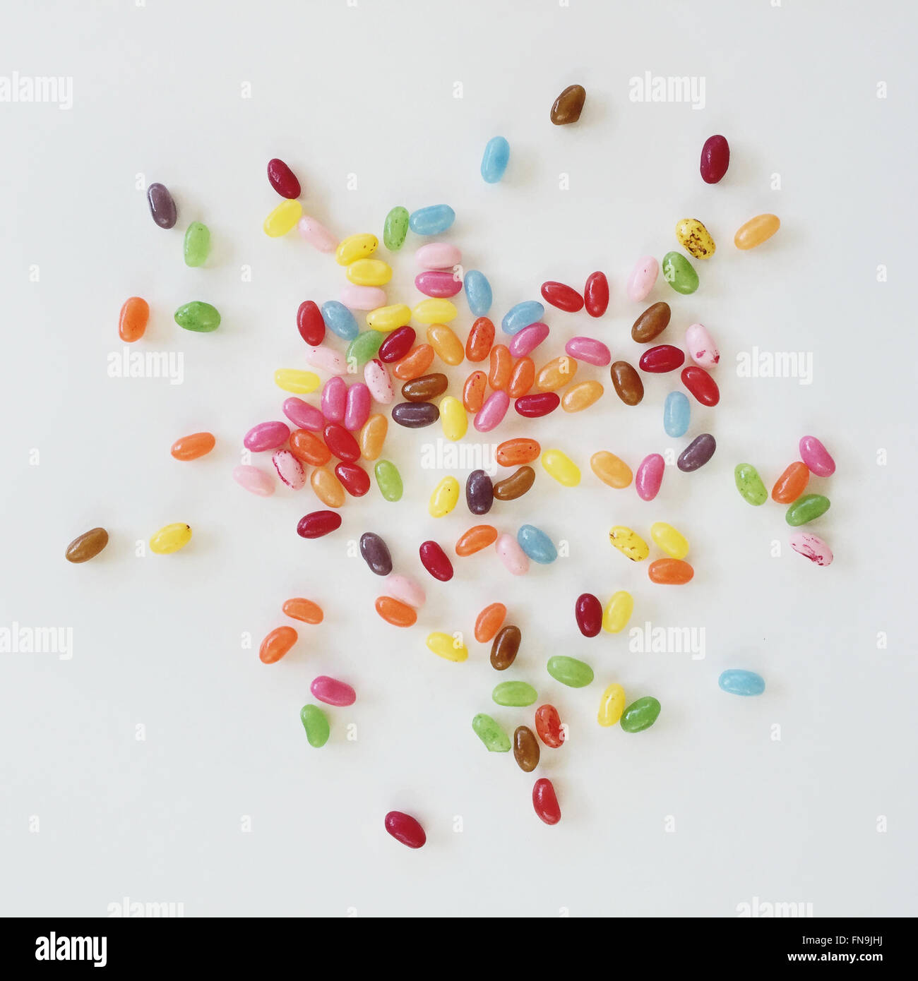 Multi-colored jelly beans on a white table Stock Photo - Alamy