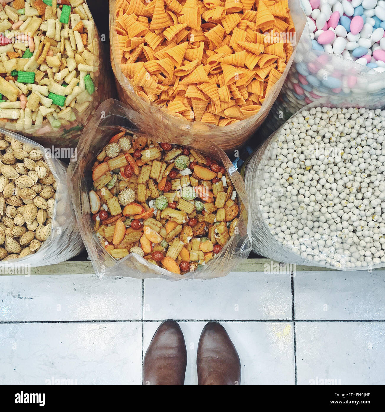 Feet standing in front of snacks in a market Stock Photo - Alamy