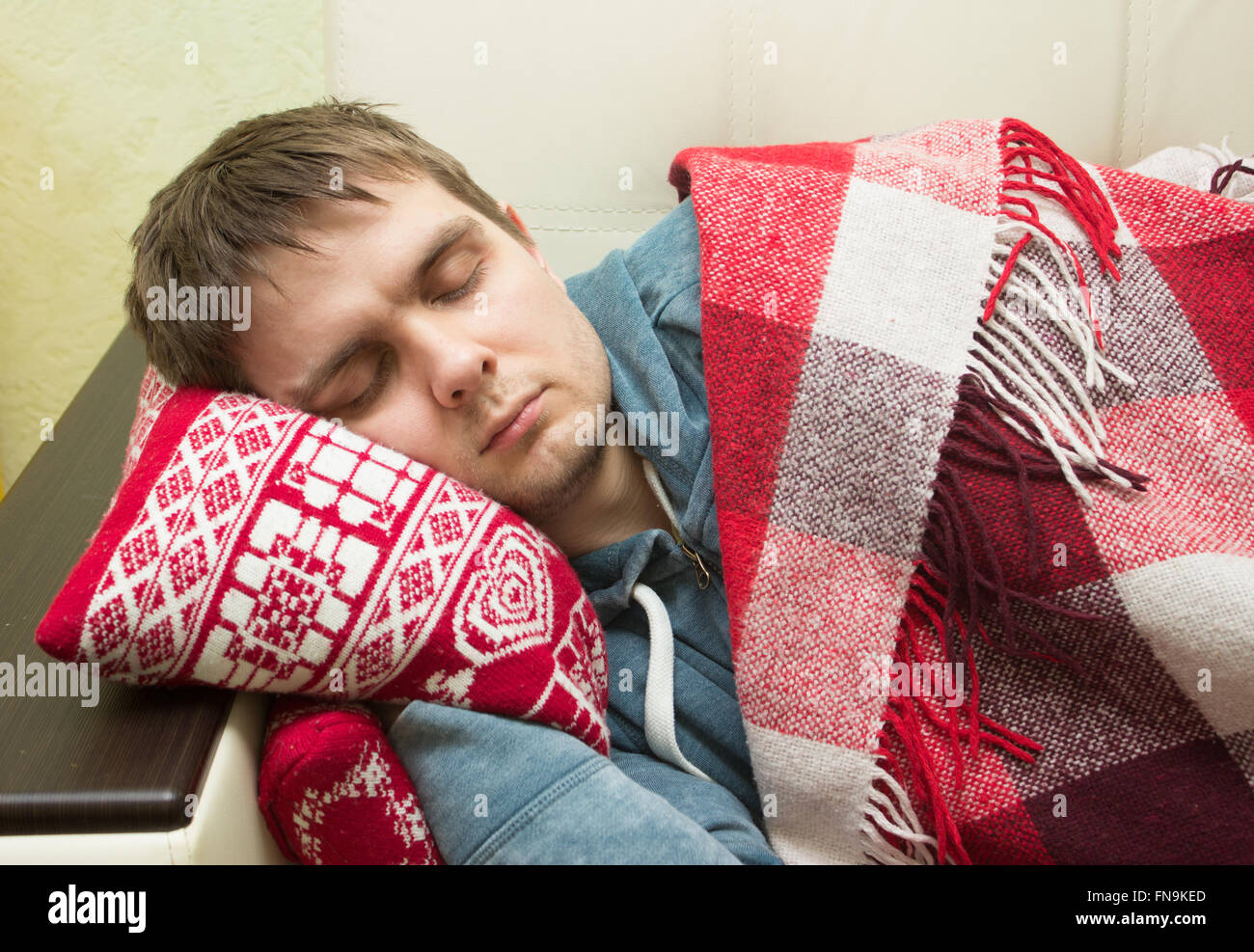 Man with fever sleeping on the sofa Stock Photo - Alamy