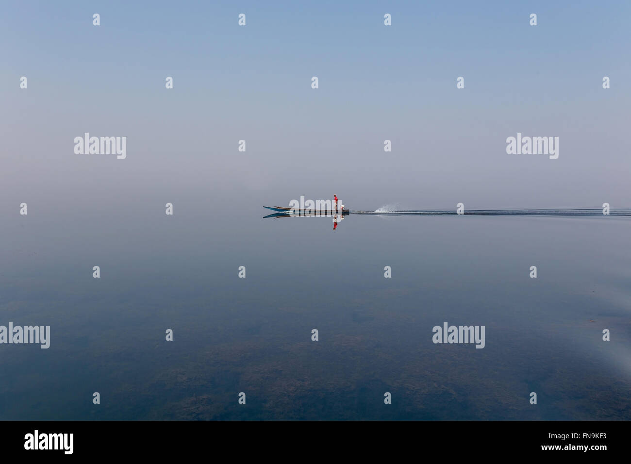Speed boat sailing across lake Stock Photo - Alamy