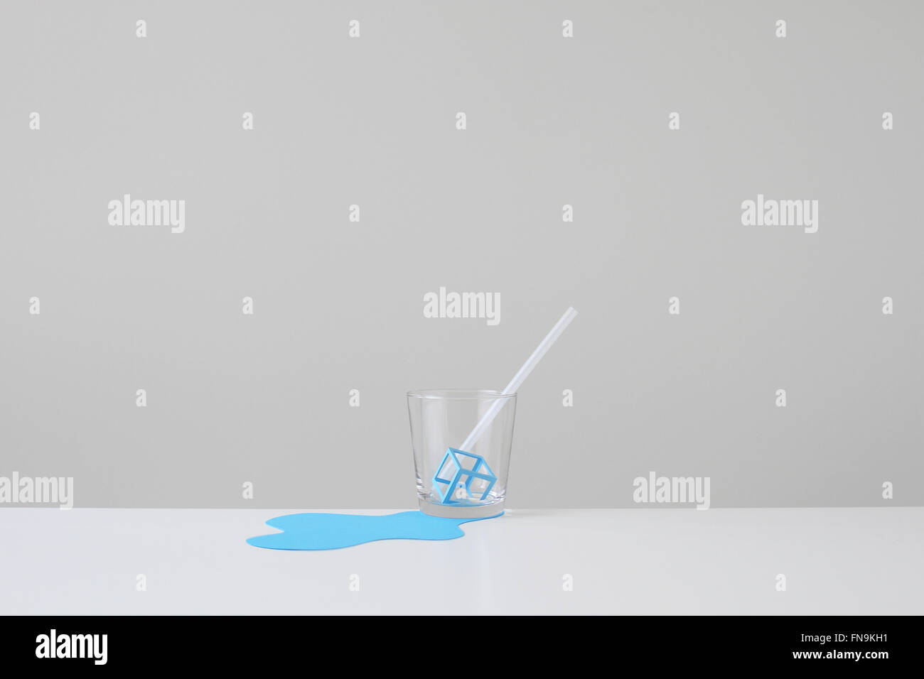 Conceptual Papermade ice melting in glass with straw Stock Photo - Alamy