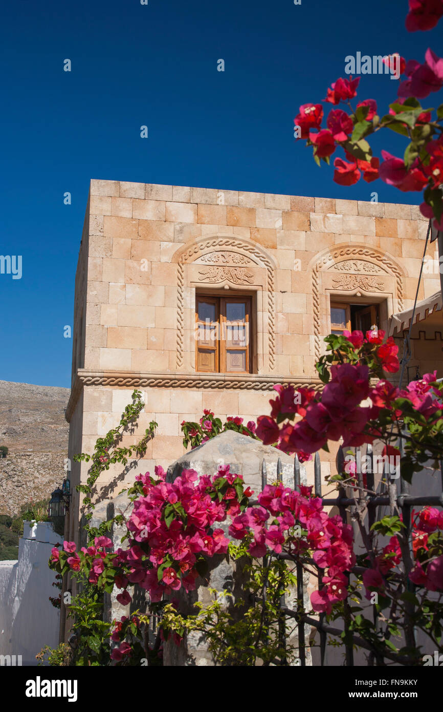 Lindos, Rhodes, South Aegean, Greece. Carved sandstone façade framed by ...