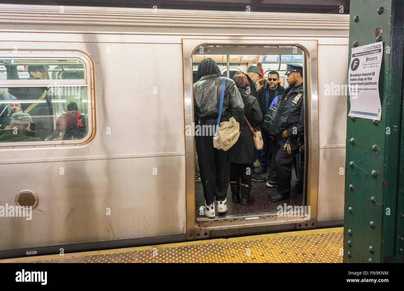 An NYPD officer is seen on a subway train in New York on Saturday ...