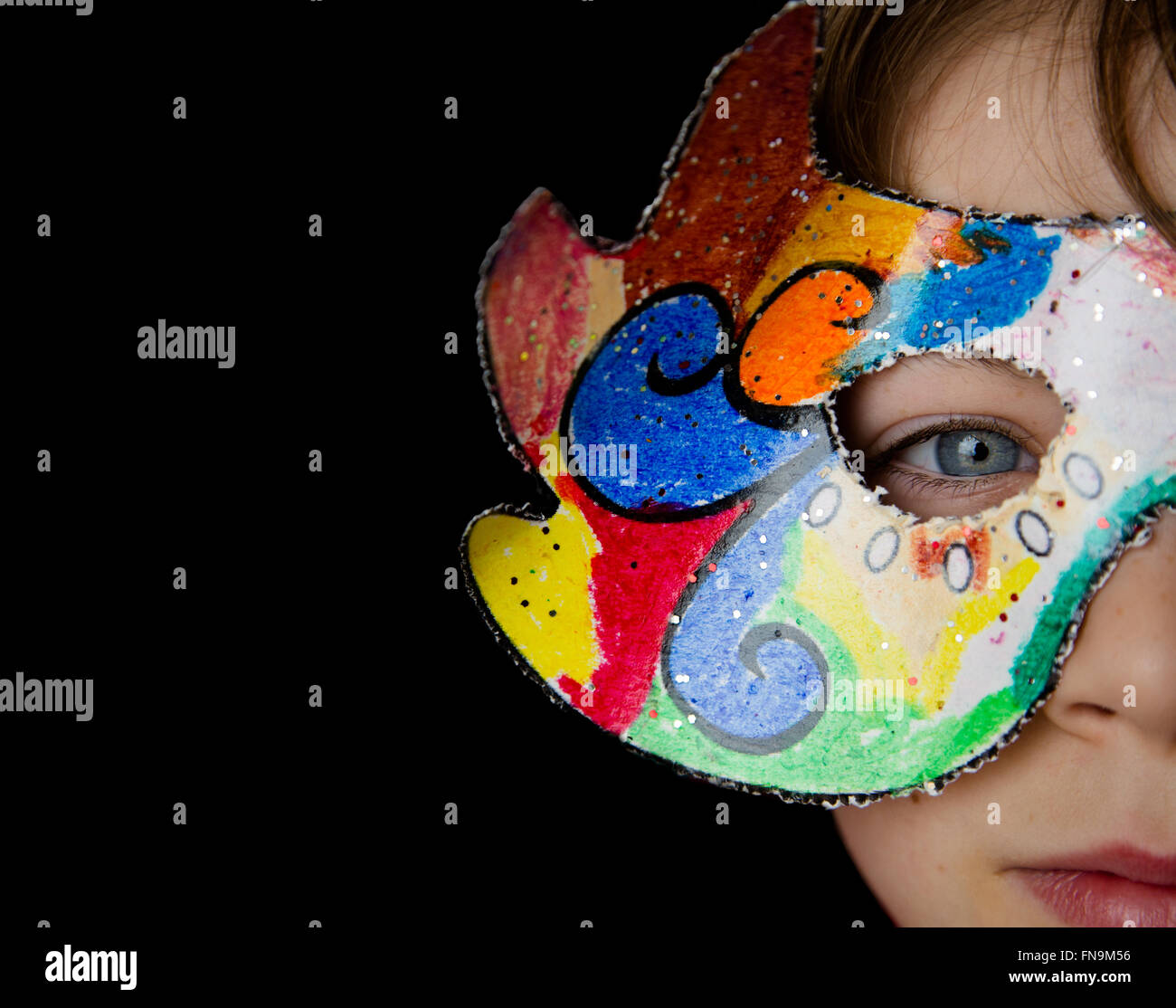 Boy wearing a multi coloured mask Stock Photo - Alamy