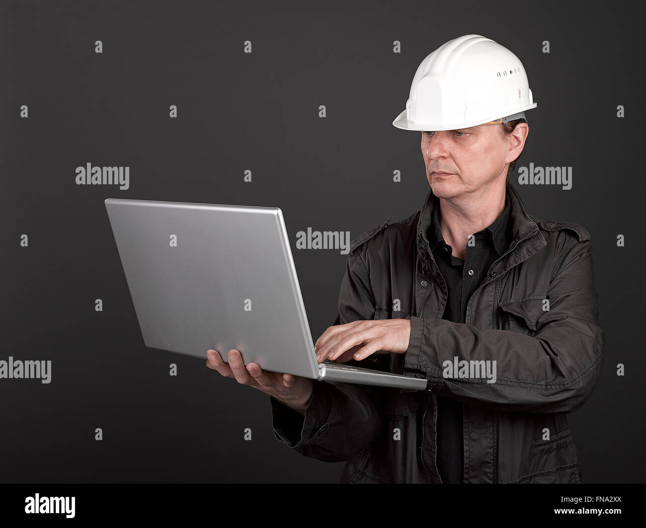 Construction worker working laptop in hi-res stock photography and ...