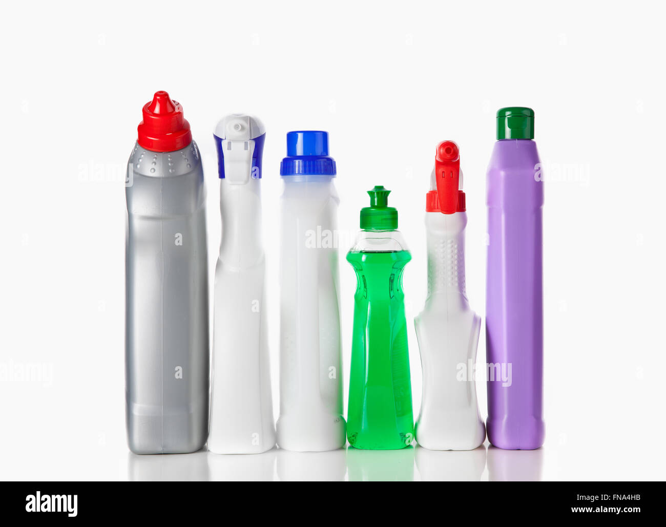 Various bottles with cleaning supplies isolated on white background ...