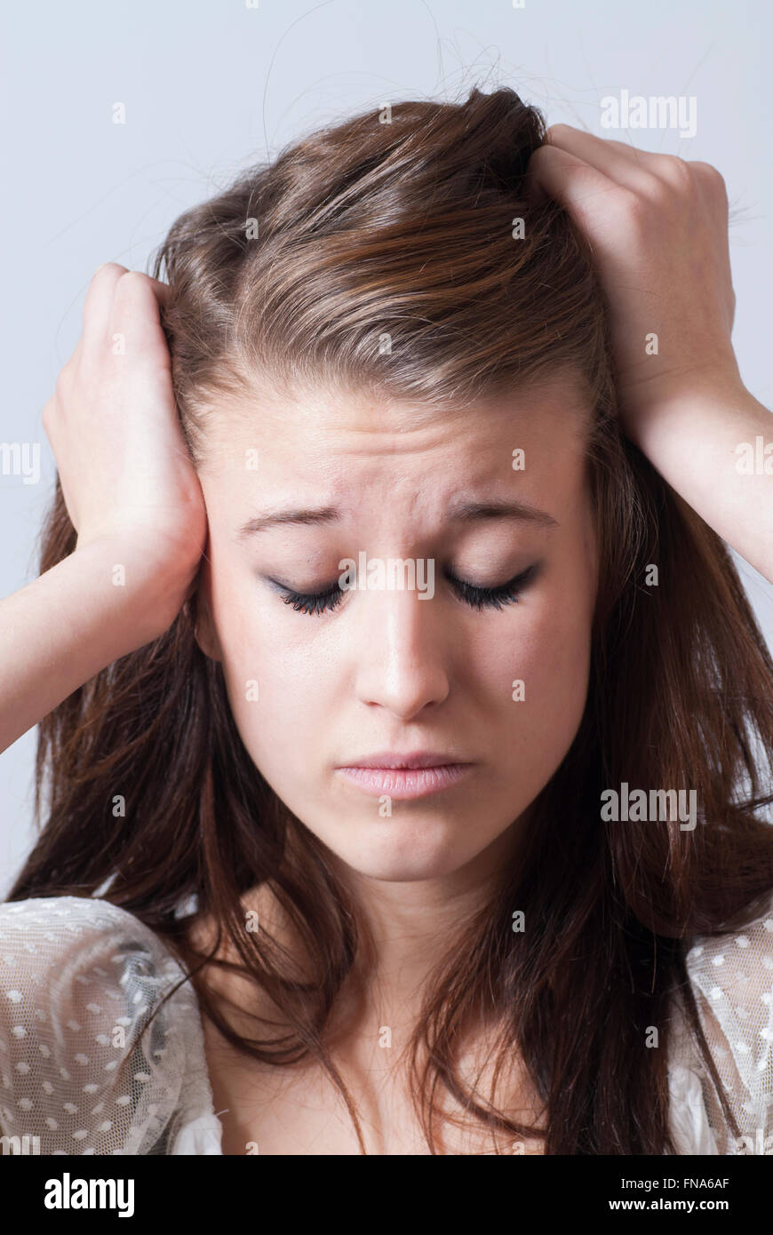 Frustrated young woman hands on head Stock Photo - Alamy